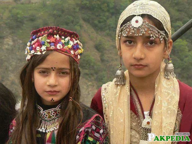 A Kalash man and baby at the summer festival of the Kalash people, in ...